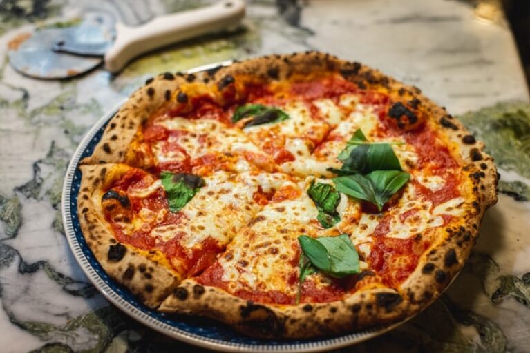 The History of Pizza - From a Neapolitan Dish to the All-American Food